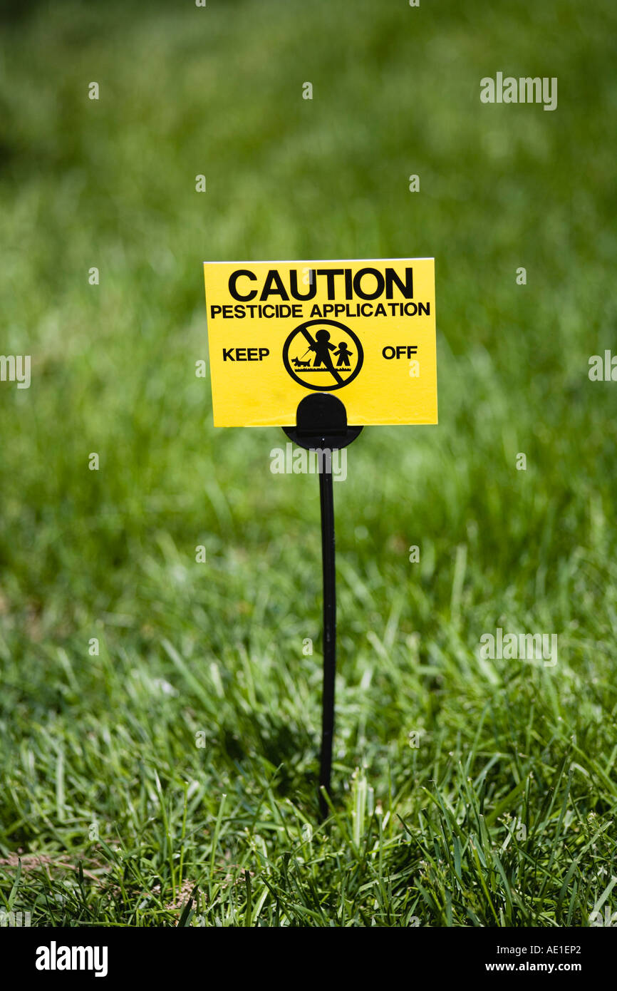 Yellow Caution Pesticide Application Keep Off sign in green grass Stock ...