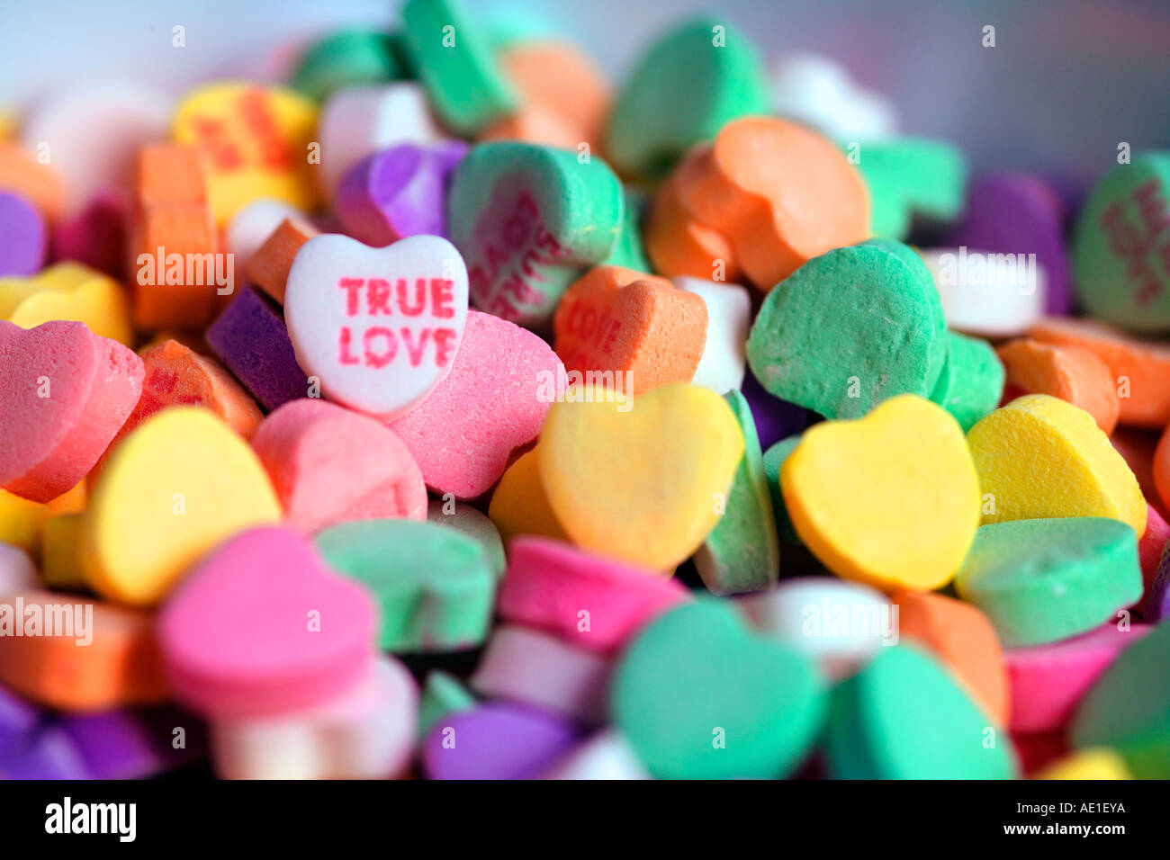 Small heart shaped candies in a pile with True Love written on one ...