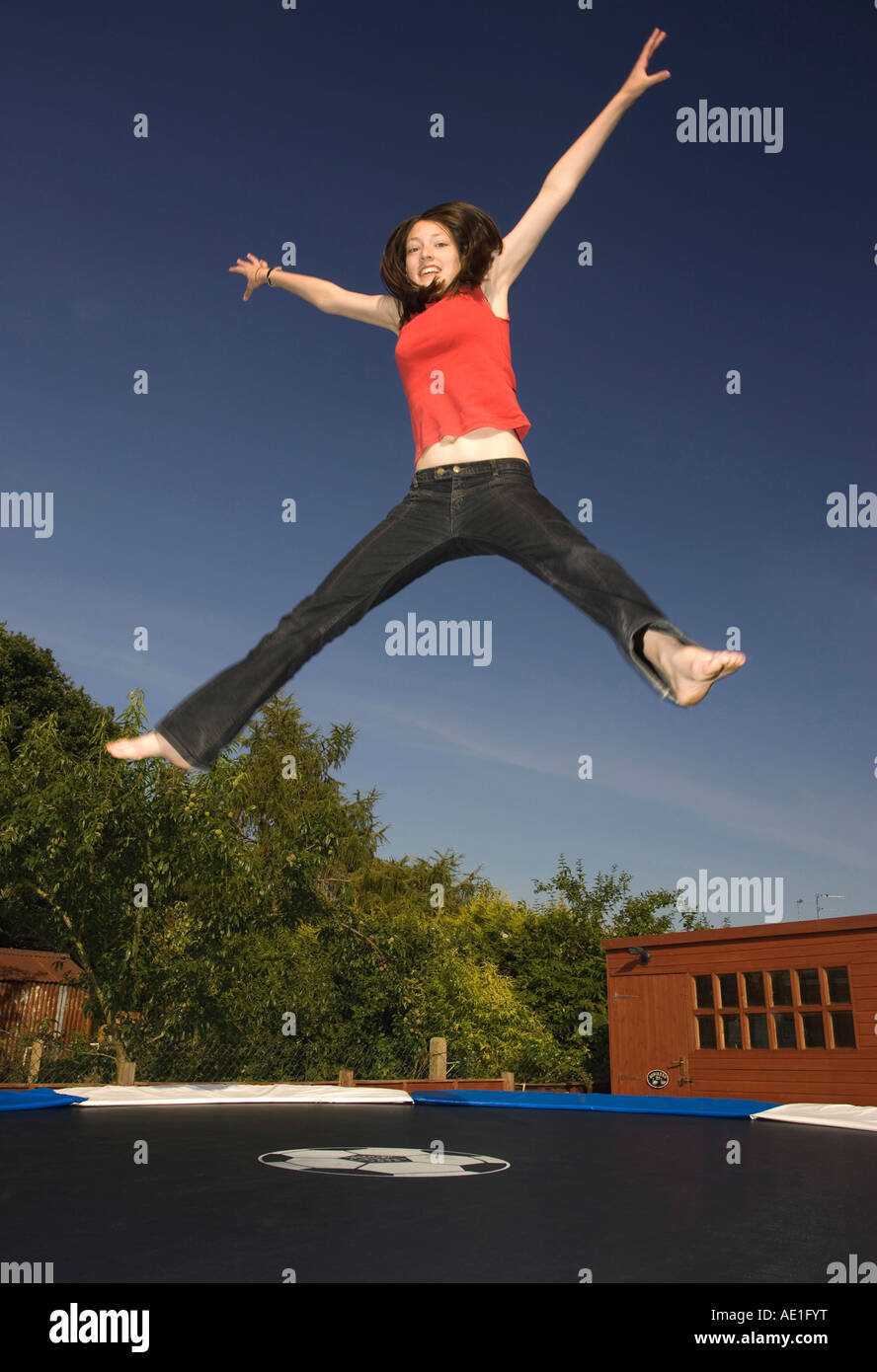 Woman Jumping On Trampoline Stock Photos & Woman Jumping On Trampoline ...