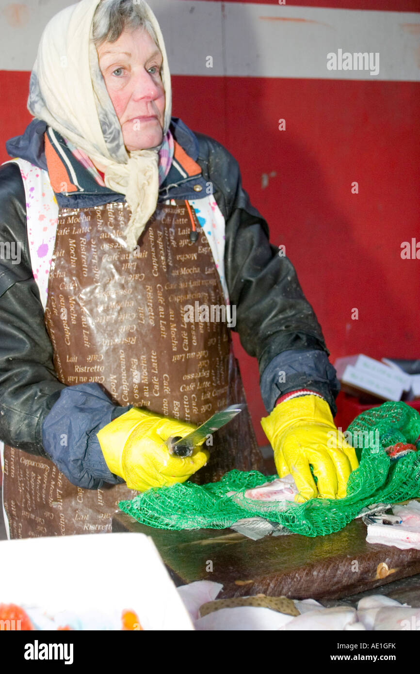 Woman cutting fish in Dublin main busy shopping centre and market in ...