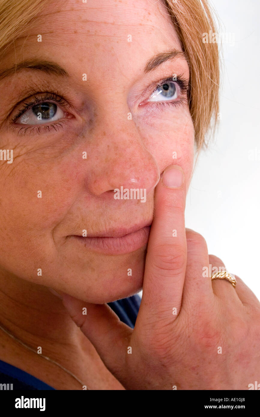 Blond middle aged Irish woman looking thoughtful Stock Photo - Alamy