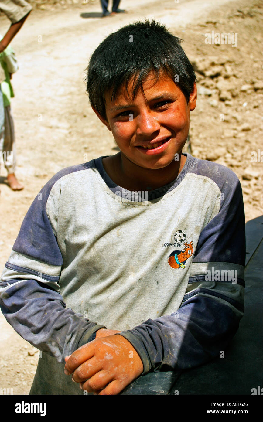 A young Iraqi boy smiles relaxes and smiles for the camera as British ...