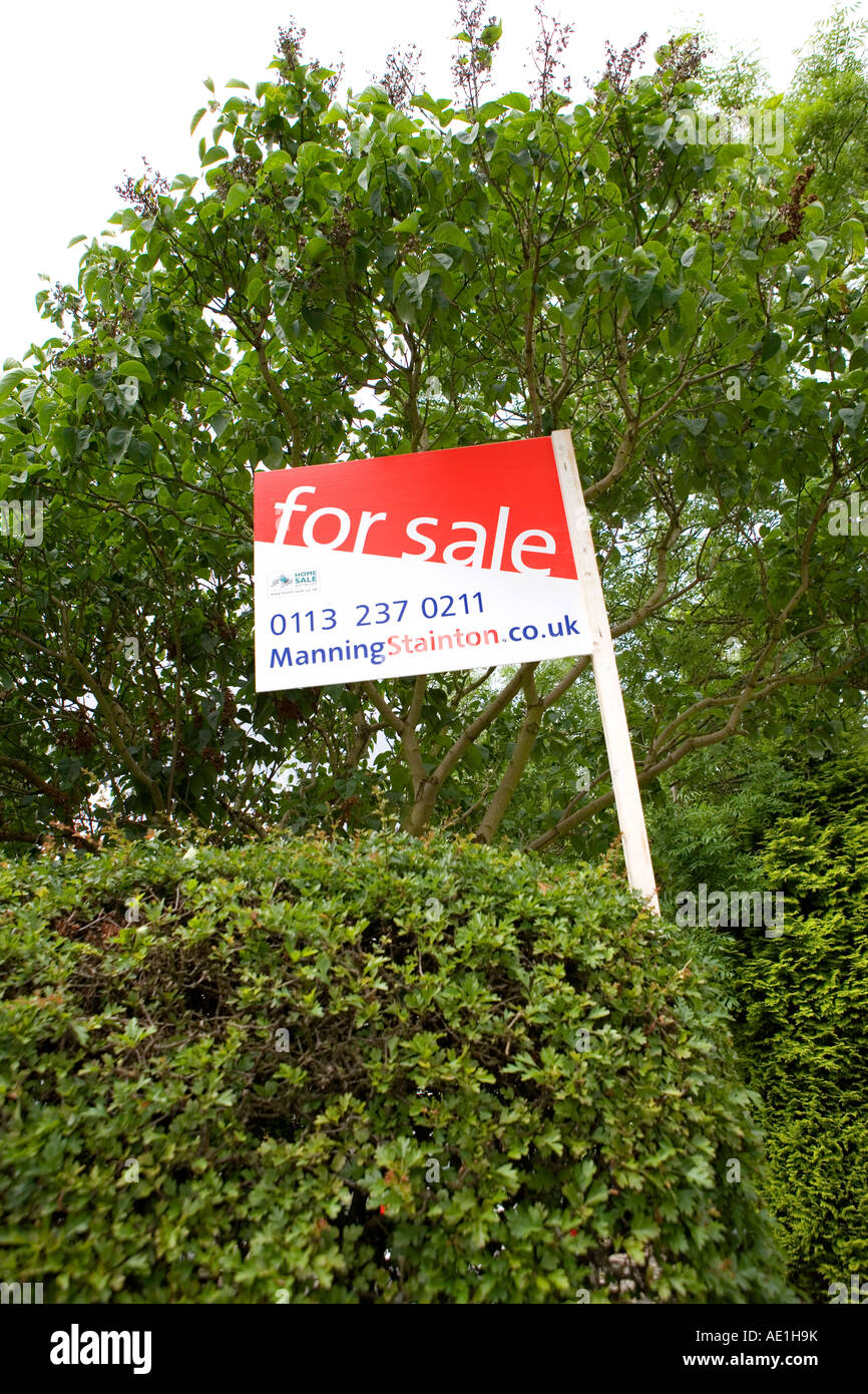 For Sale sign in green bush Stock Photo - Alamy