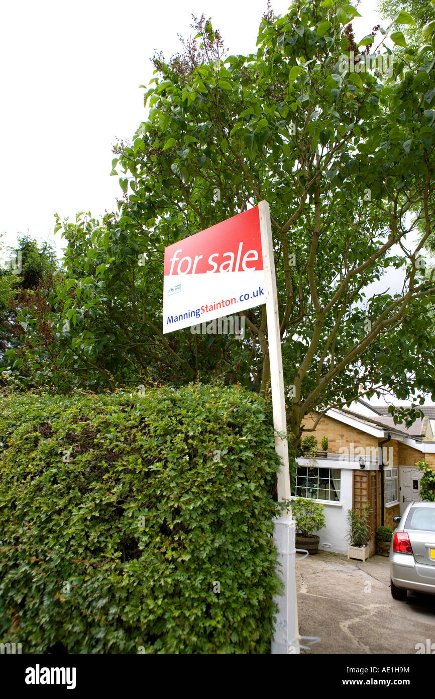 For Sale sign in green bush Stock Photo - Alamy