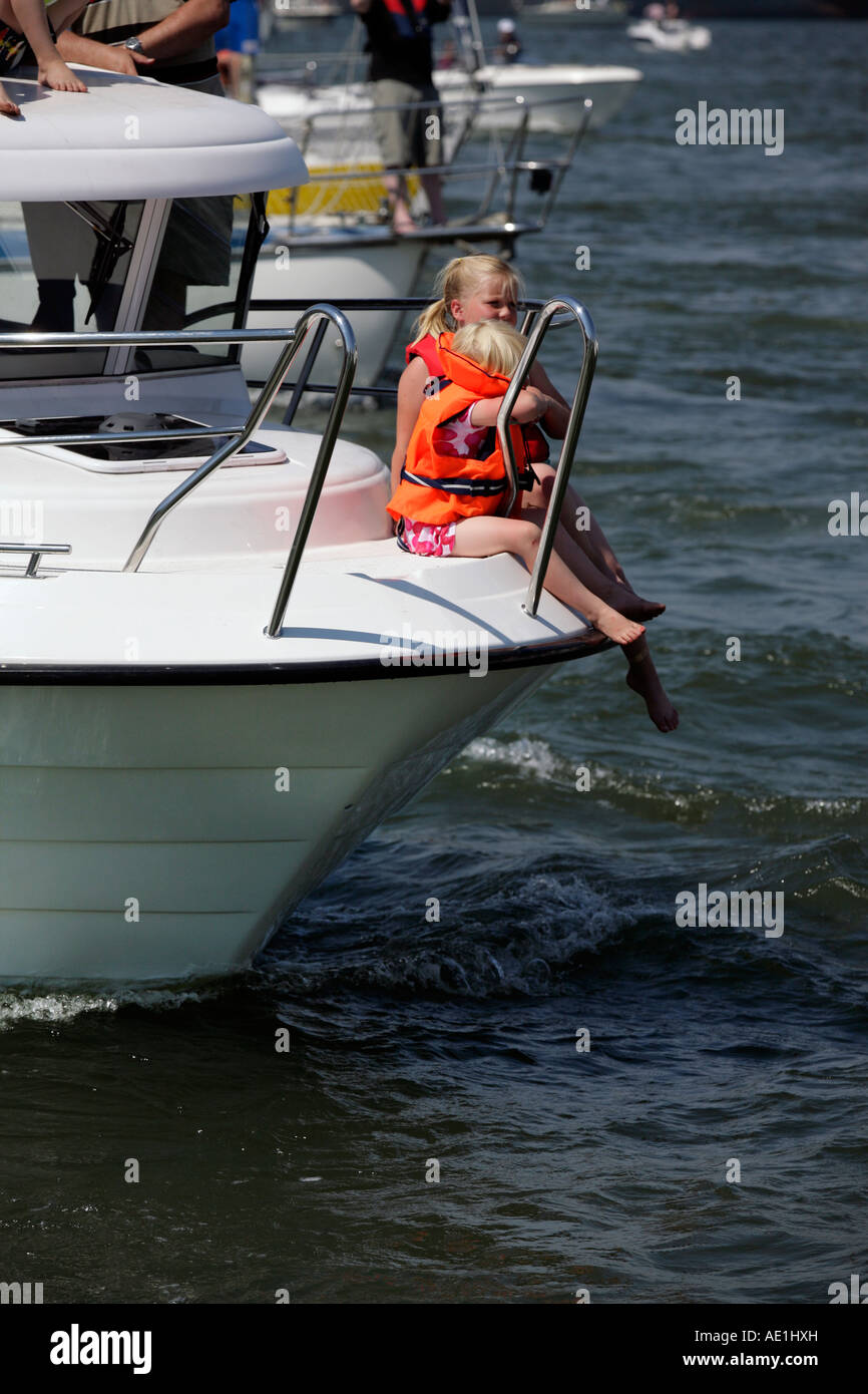 Children enjoying ride on a bow of a boat Gota river estuary Gothenburg ...