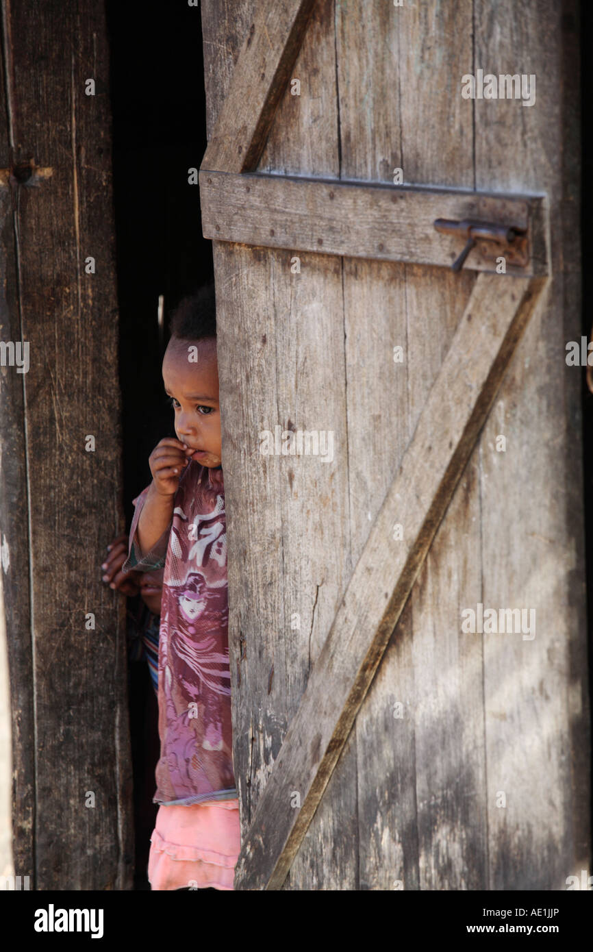Little child appearing at the door, Evatra village, near Fort Dauphin ...