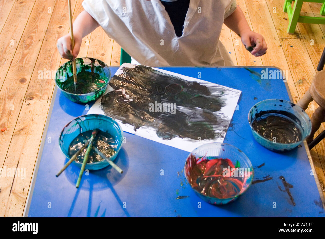 Small boy painting at play school Stock Photo - Alamy