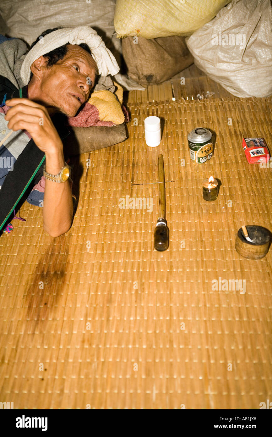 Akha man at North Thailand smoking heroin Stock Photo - Alamy