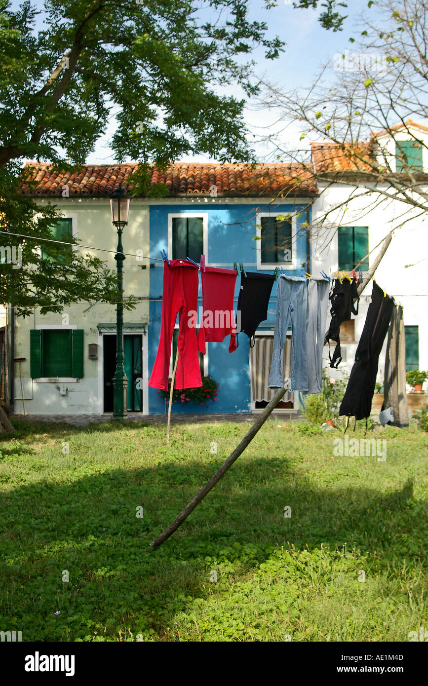 A line of laundry against coloured houses Stock Photo - Alamy