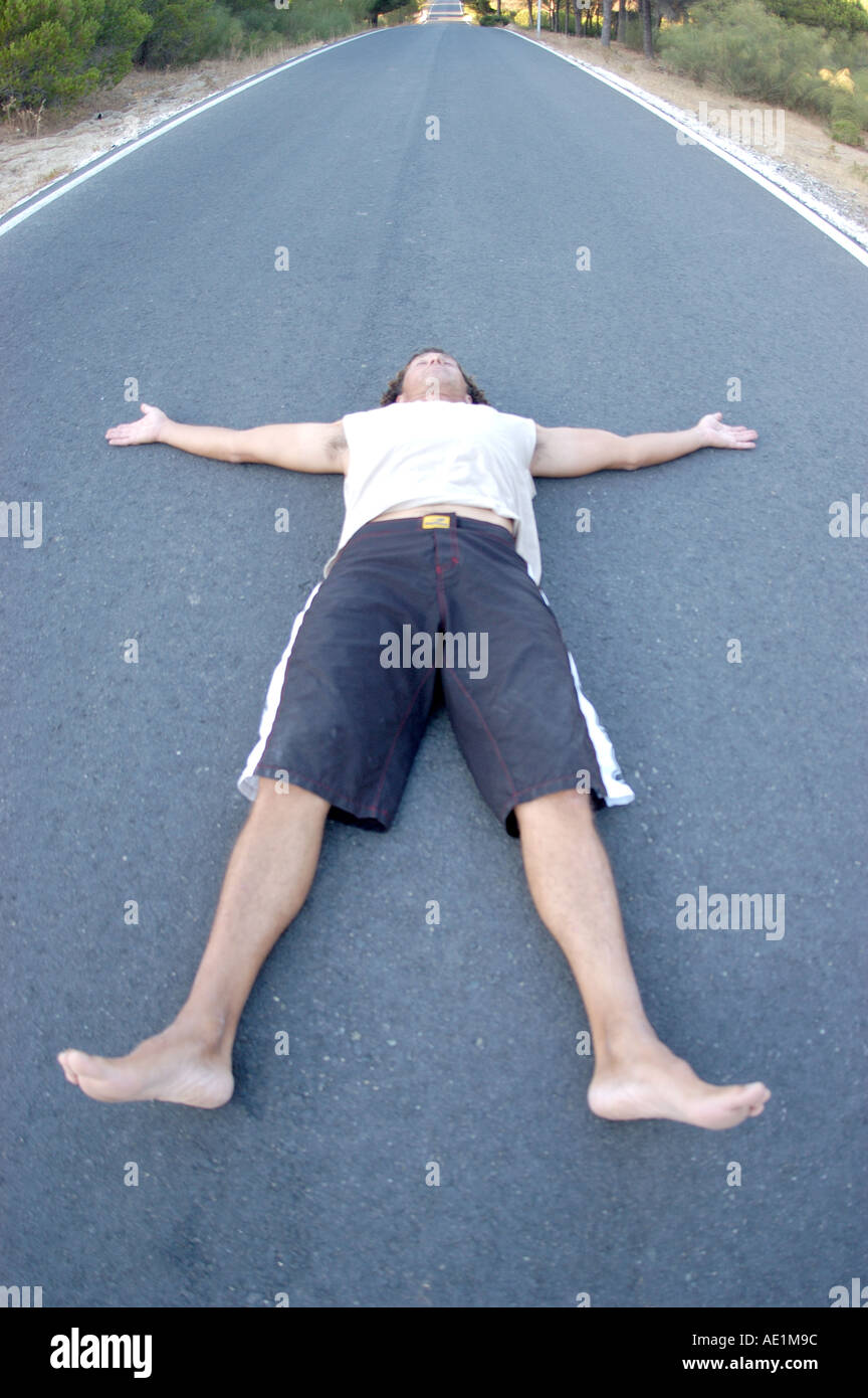 man laying on the road Stock Photo - Alamy