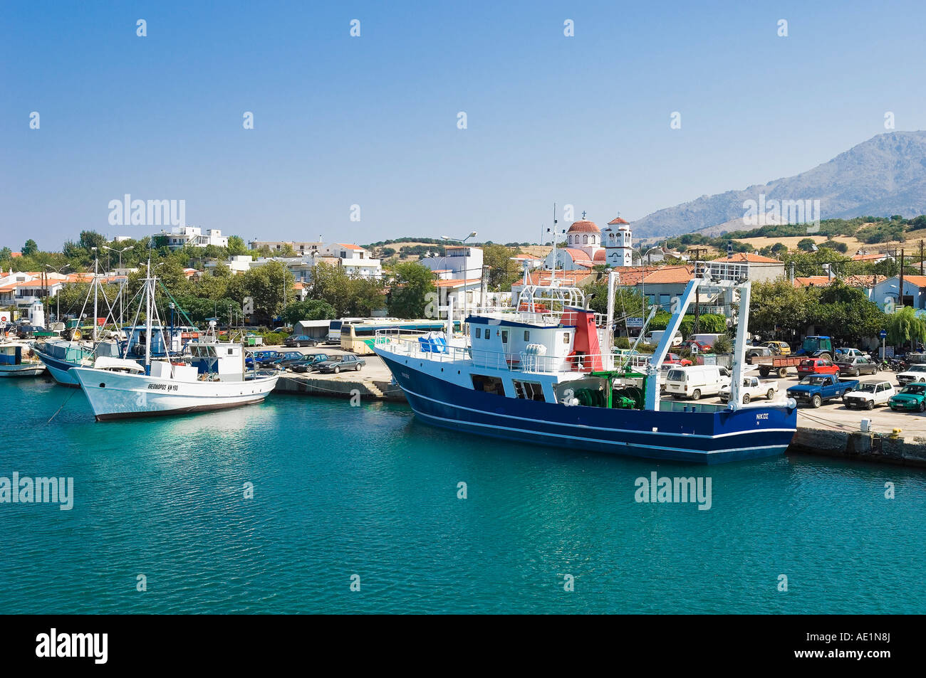 A blue and a white boat in Kamariotisa port at Samothraki Island with ...