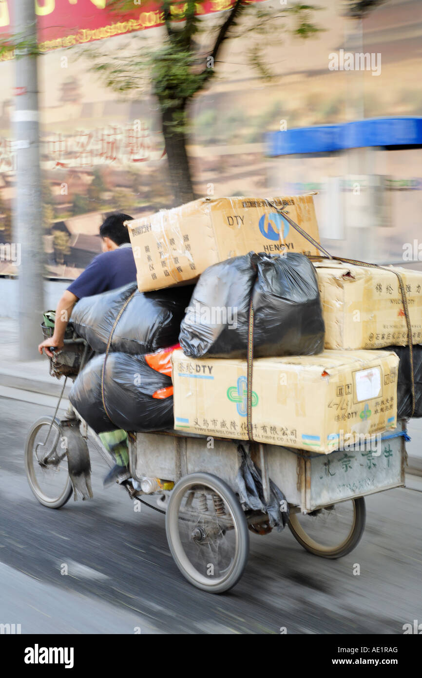 Man pedaling tricycle filled with stacked boxes Beijing China Asia ...