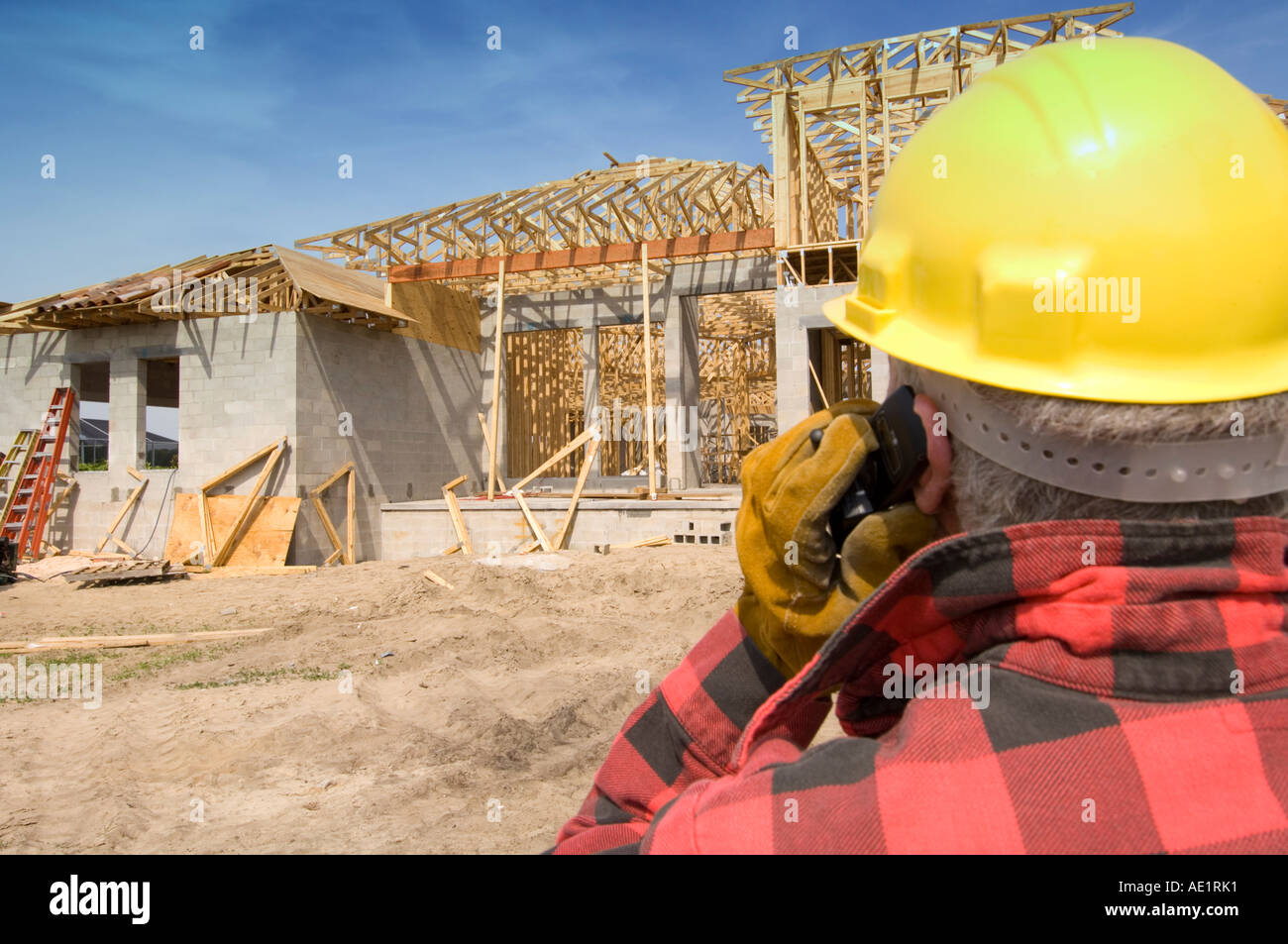 contractor on building site surveying construction progress Stock Photo ...
