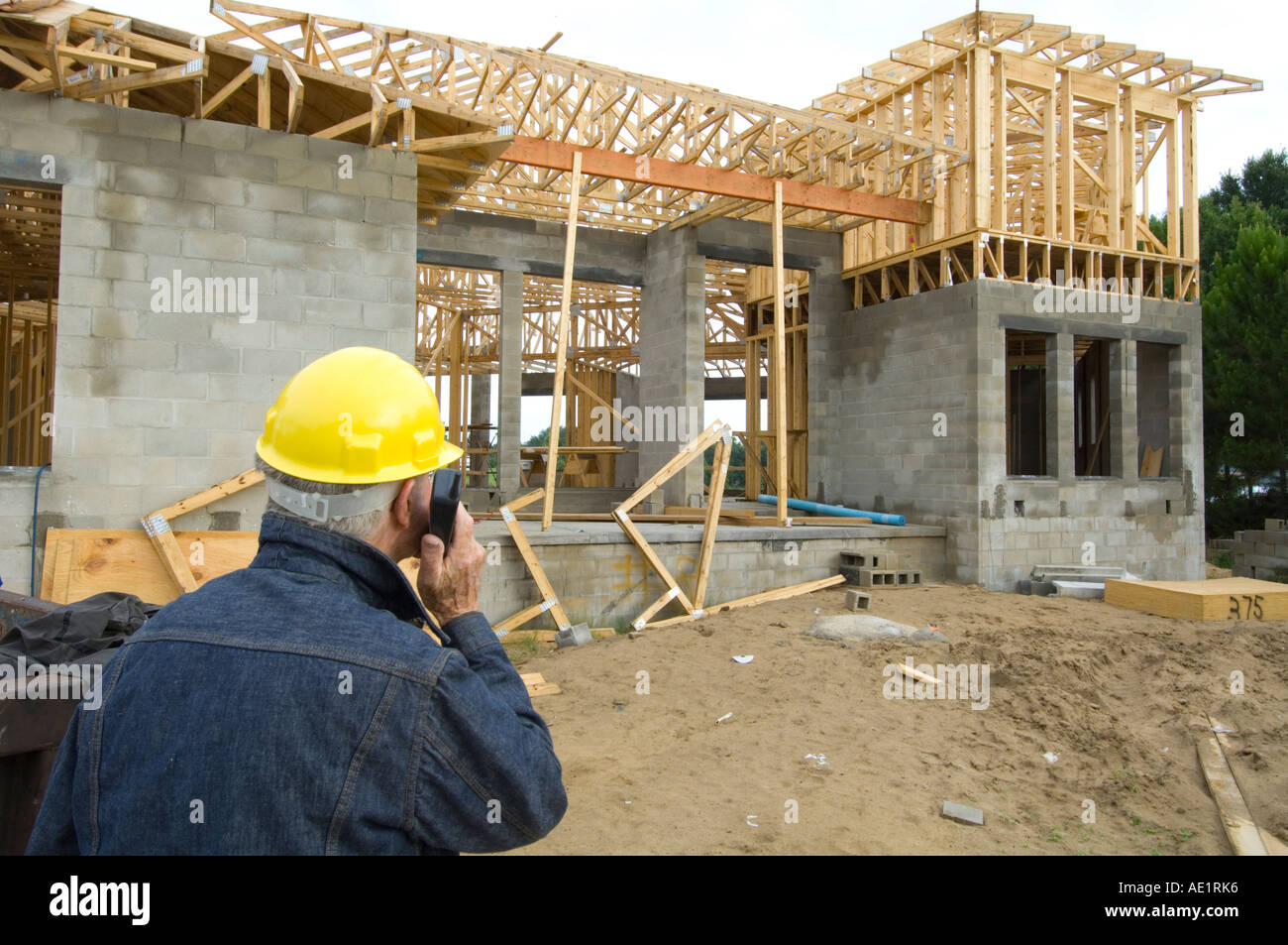 contractor on building site surveying construction progress Stock Photo ...