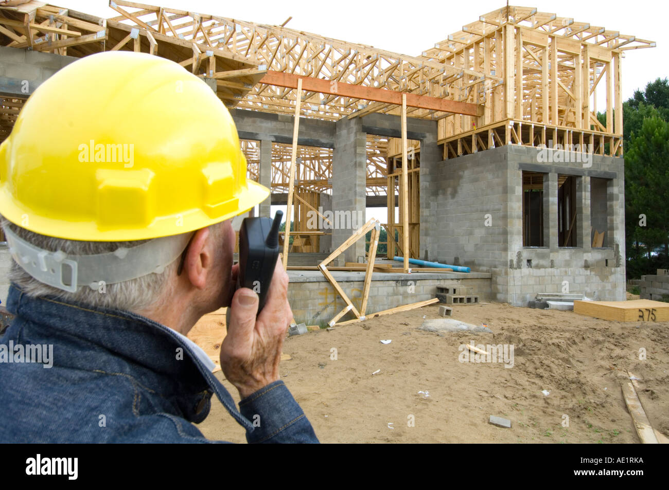 contractor on building site surveying construction progress Stock Photo ...