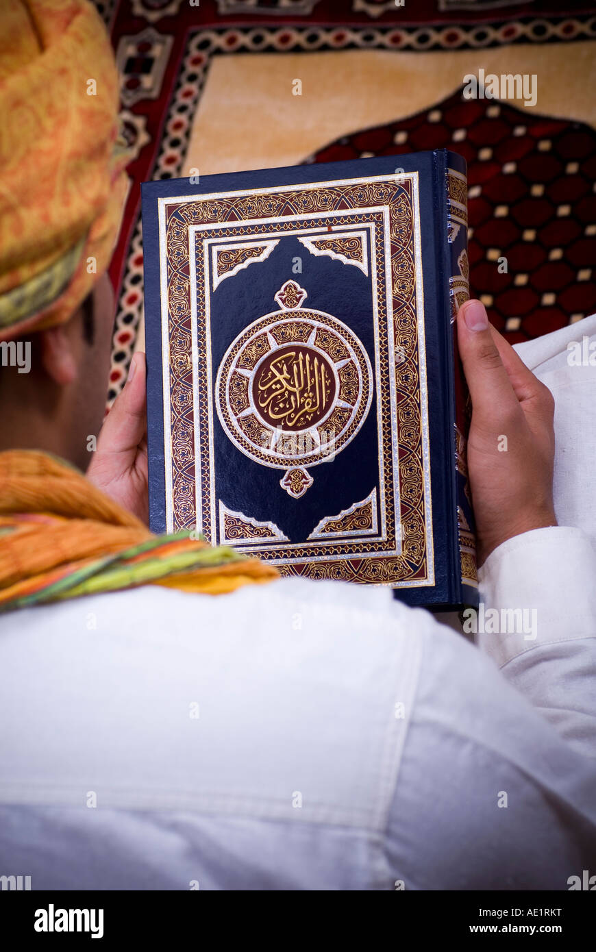 Man holding Quran Stock Photo - Alamy