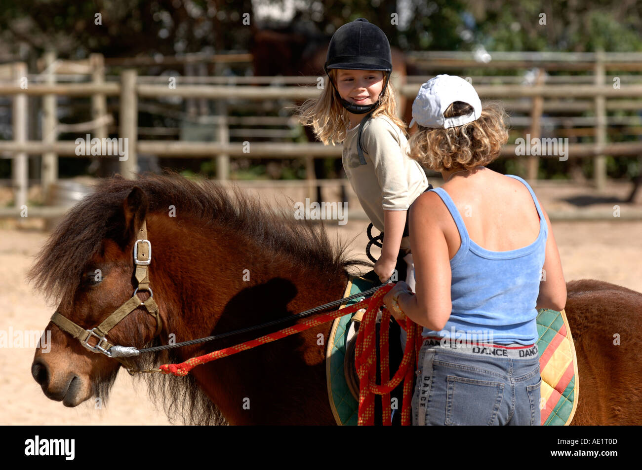girl having lesson of pony riding Stock Photo - Alamy