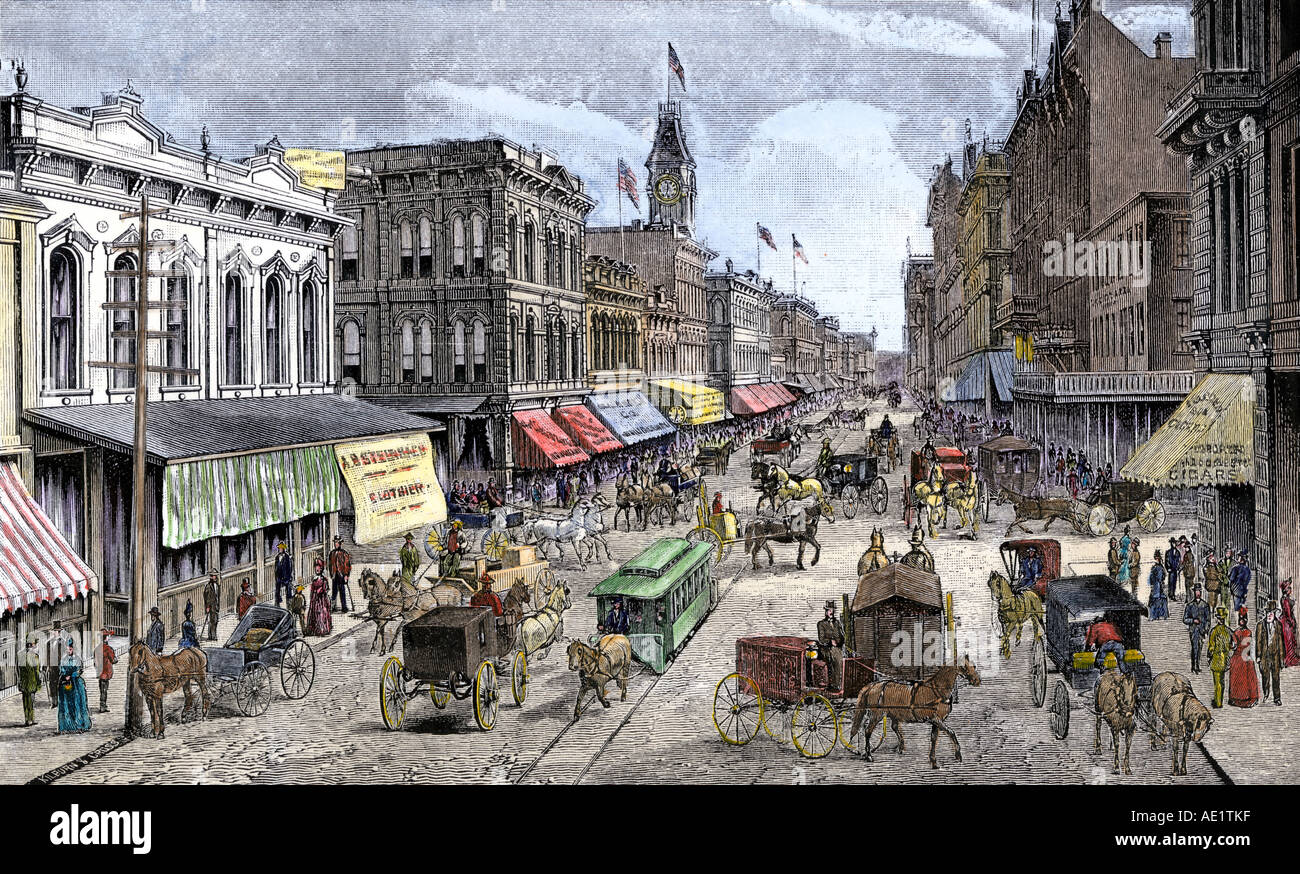 Portland Oregon street filled with carriages and shops late 1800s. Hand ...