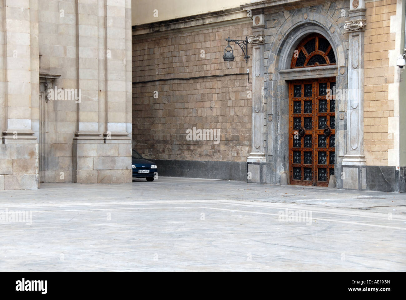 Parked car peeking from between two buildings Stock Photo - Alamy