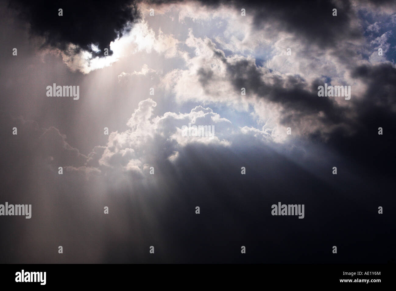 Rays of light breaking through dark clouds Stock Photo - Alamy