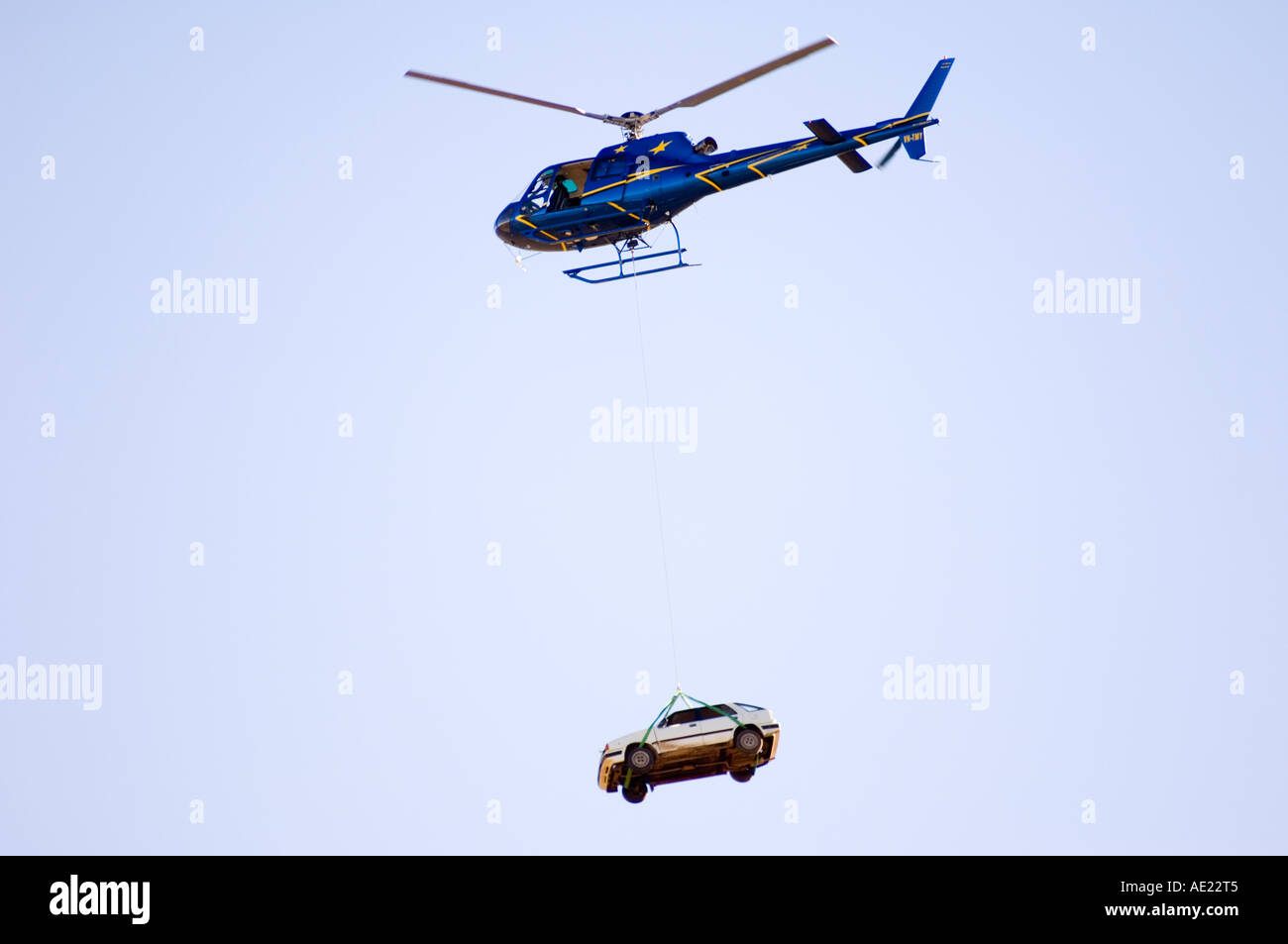A flying helicopter carrying a suspended car beneath it, one way to ...