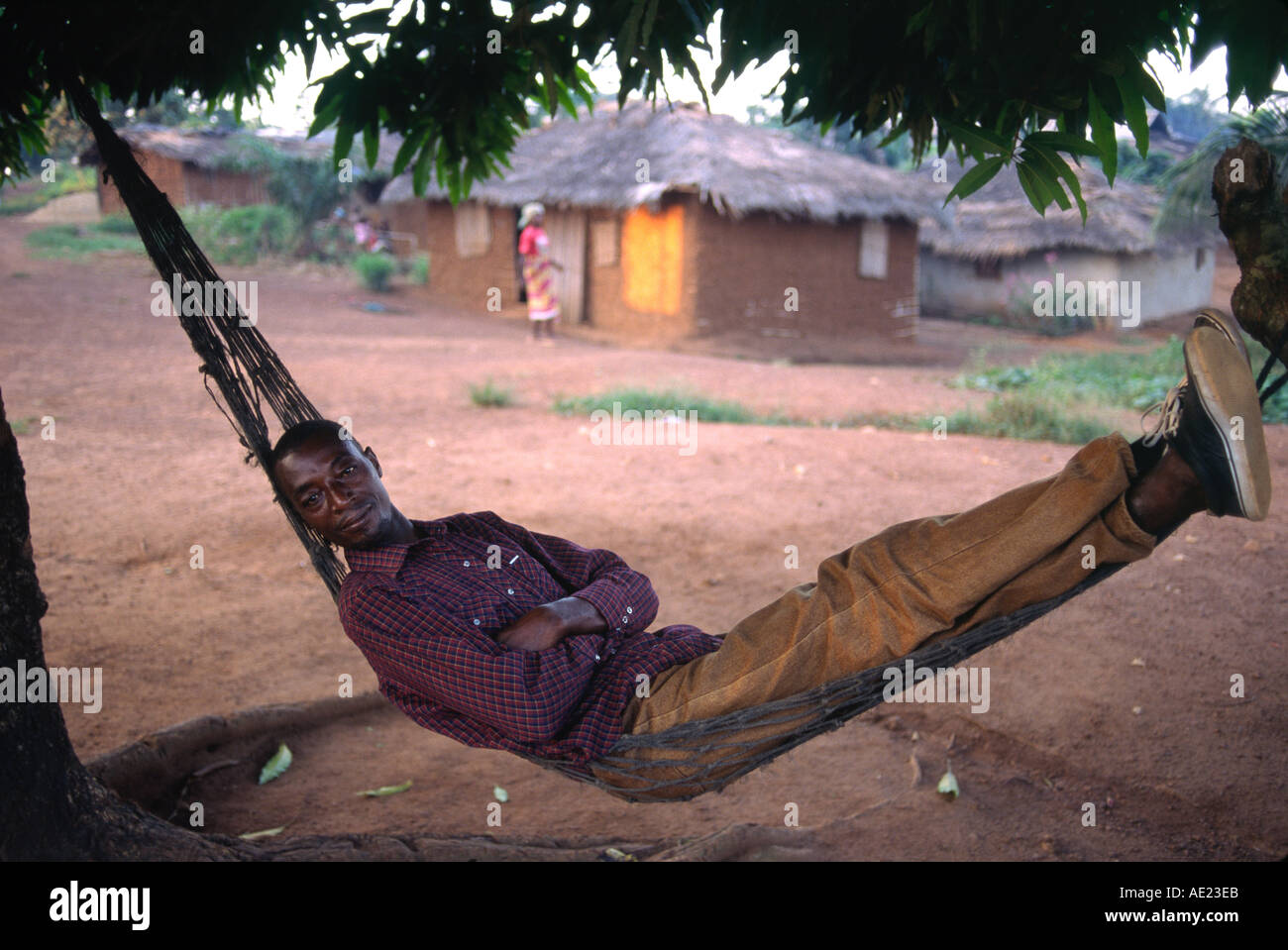 A Liberian man rests in a hammock in a refugee camp near the Liberian ...