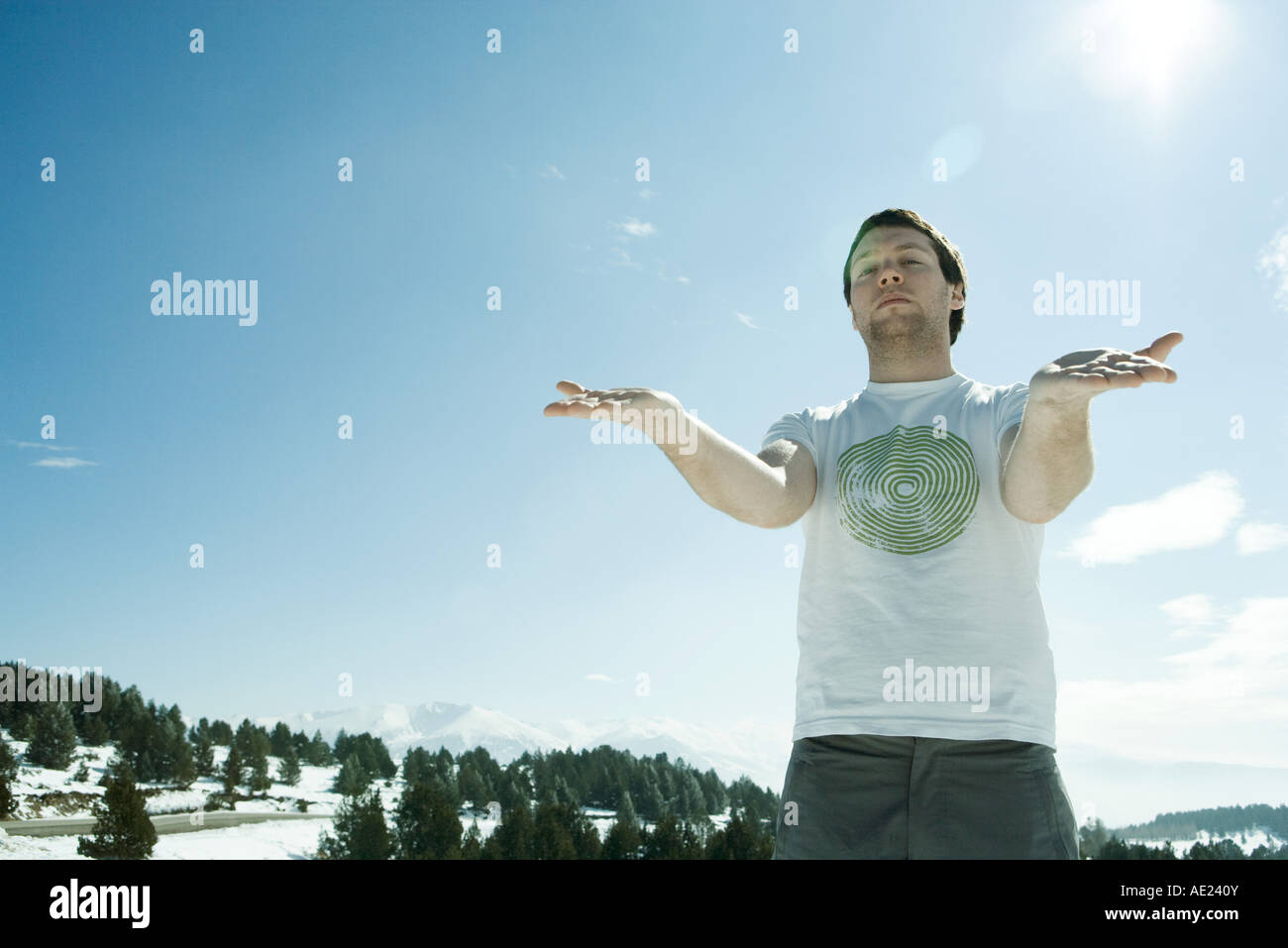 Young man standing in snowy landscape, arms out Stock Photo - Alamy