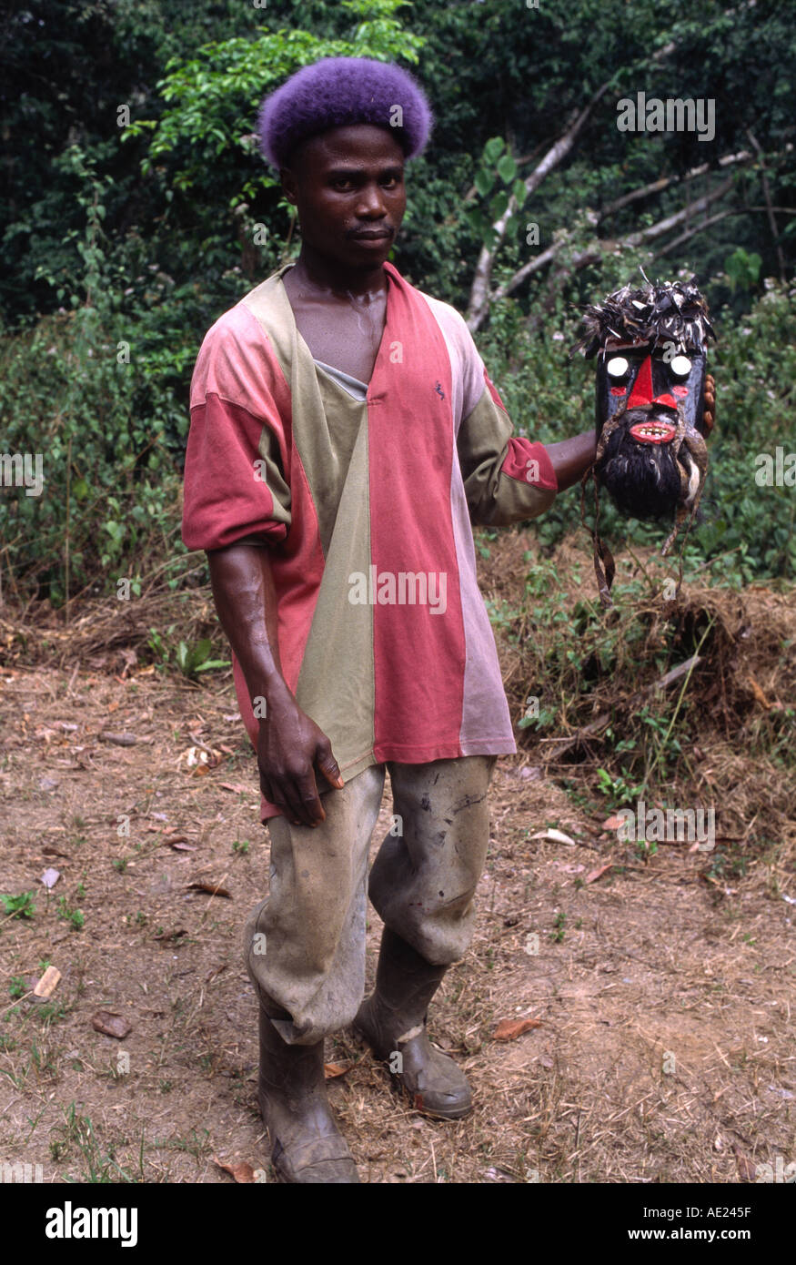 A man holds a traditional animist tribal mask Stock Photo - Alamy
