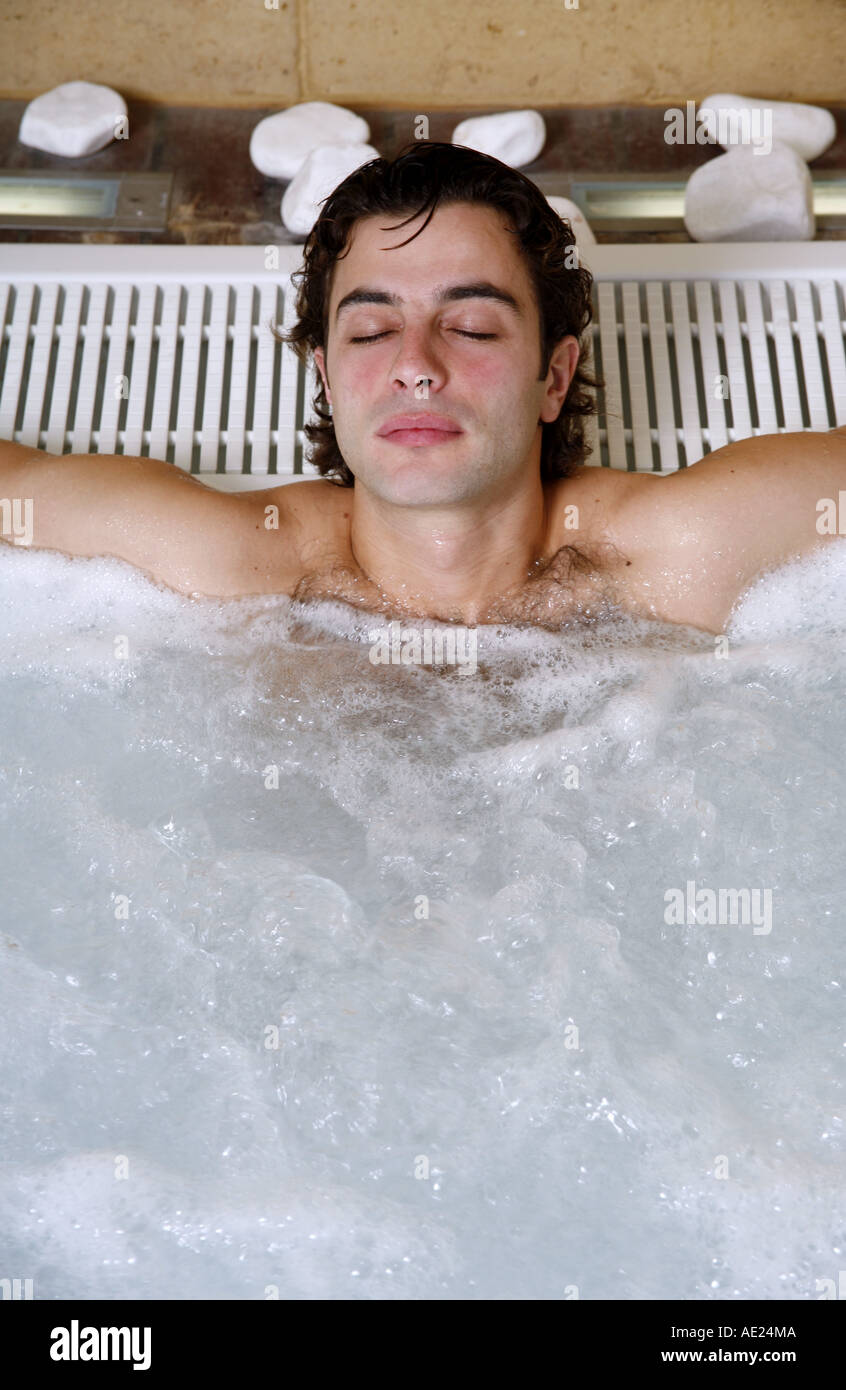 Young man in jacuzzi at a spa Stock Photo - Alamy