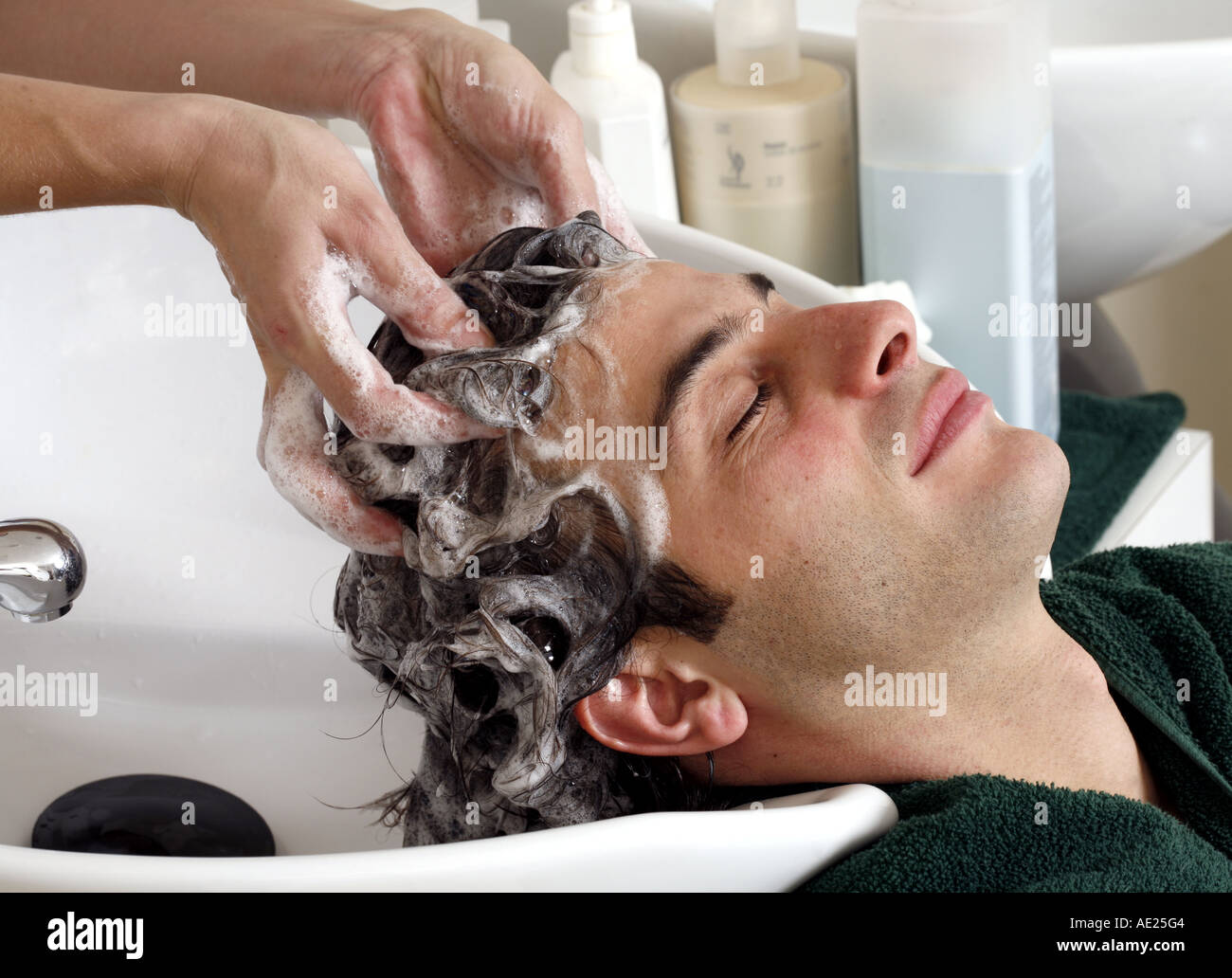 Young man having his hair washed at a salon Stock Photo - Alamy