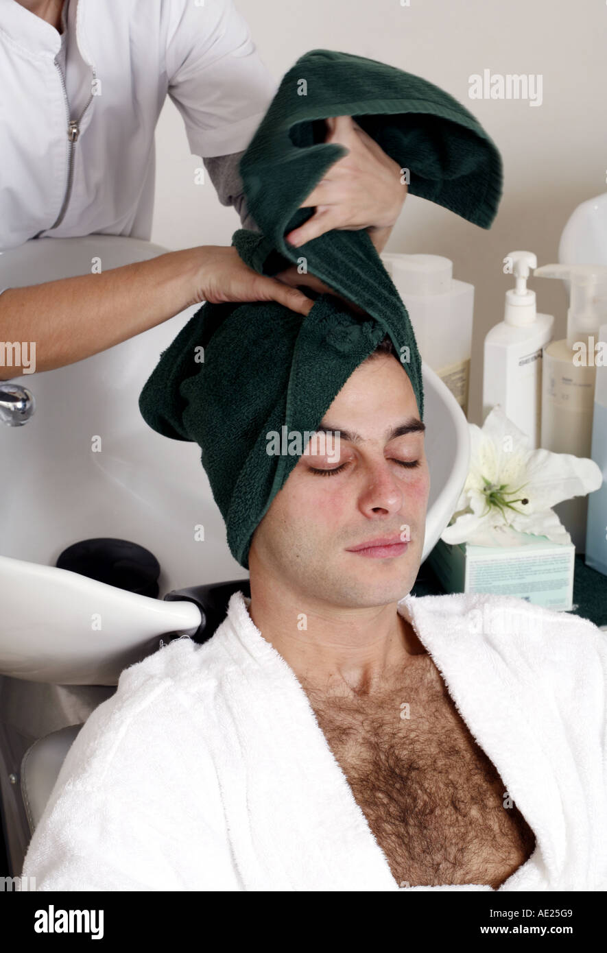 Young man having his hair washed at a salon Stock Photo - Alamy
