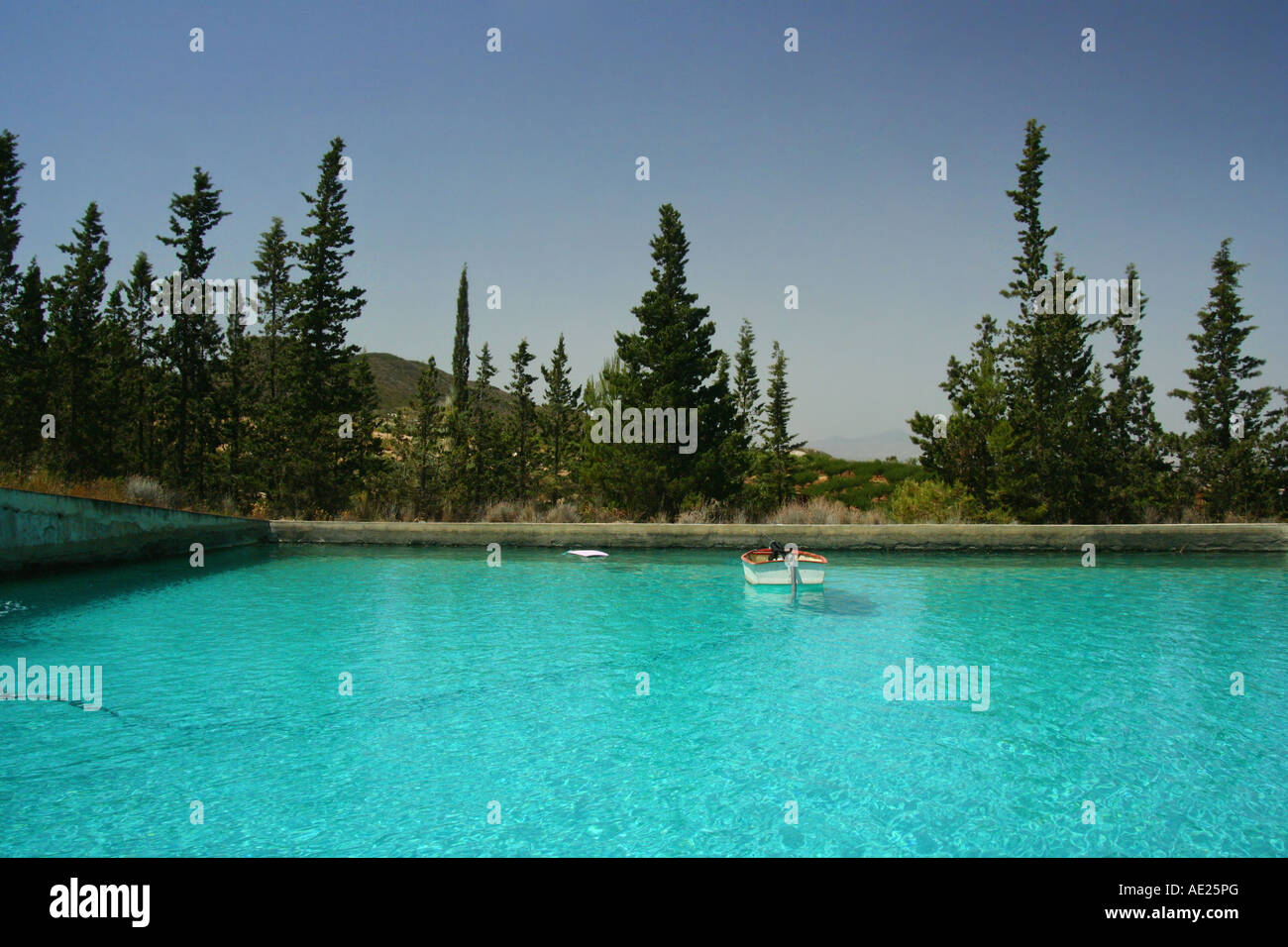 Artificial pool with cypress trees around Stock Photo - Alamy