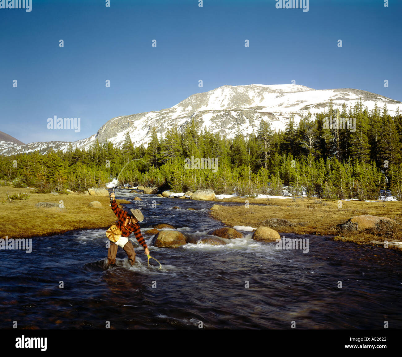 man fishing in Merced River in Yosemite National Park in California USA ...