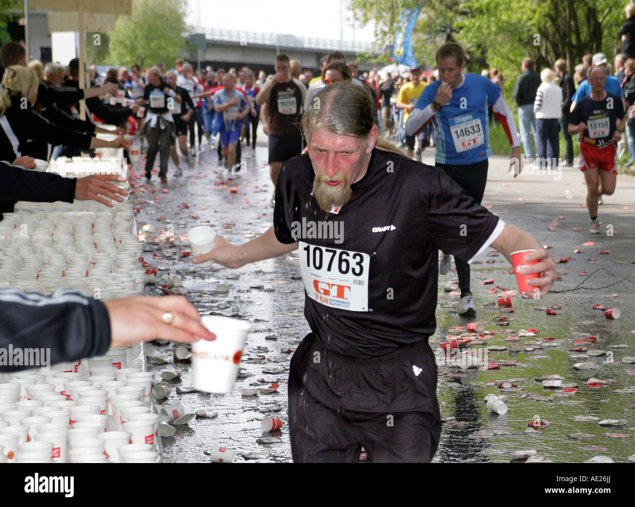A man reaching refreshment point at marathon run Stock Photo - Alamy