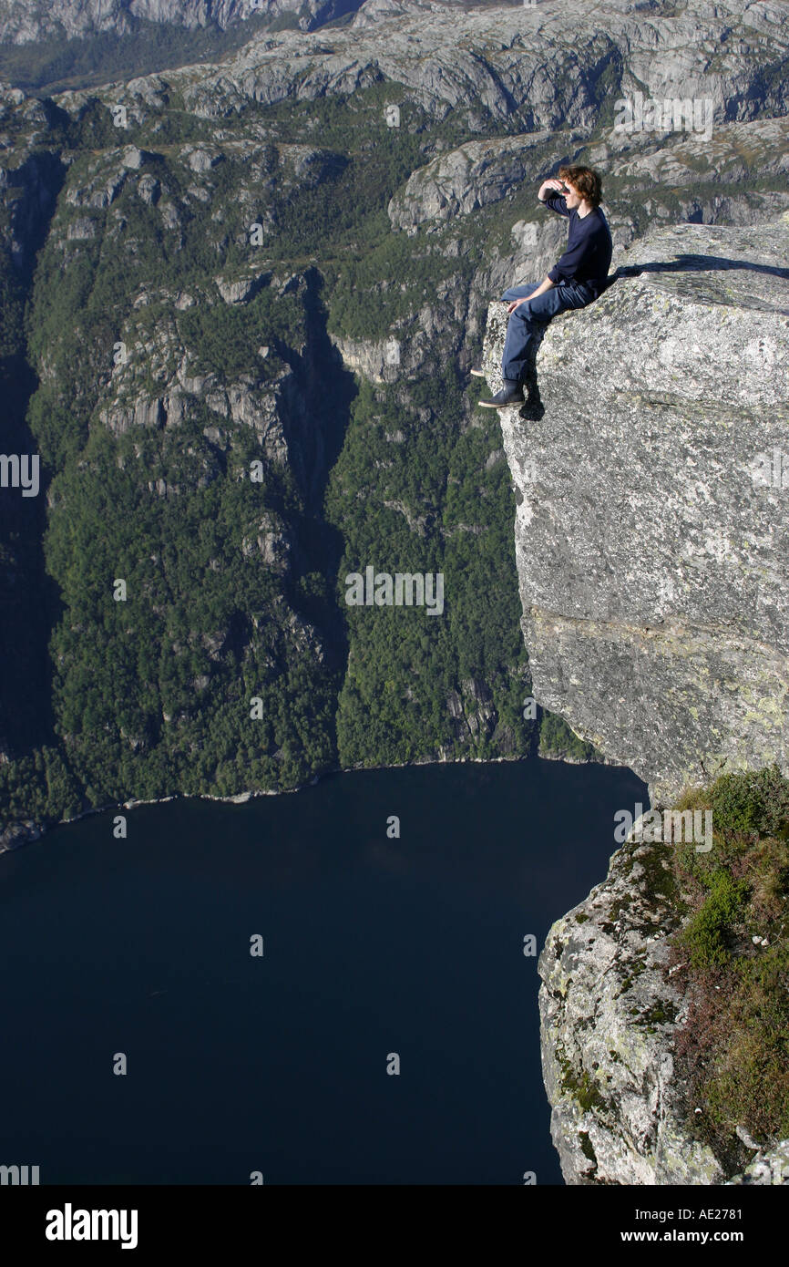 Man sitting on edge Stock Photo - Alamy