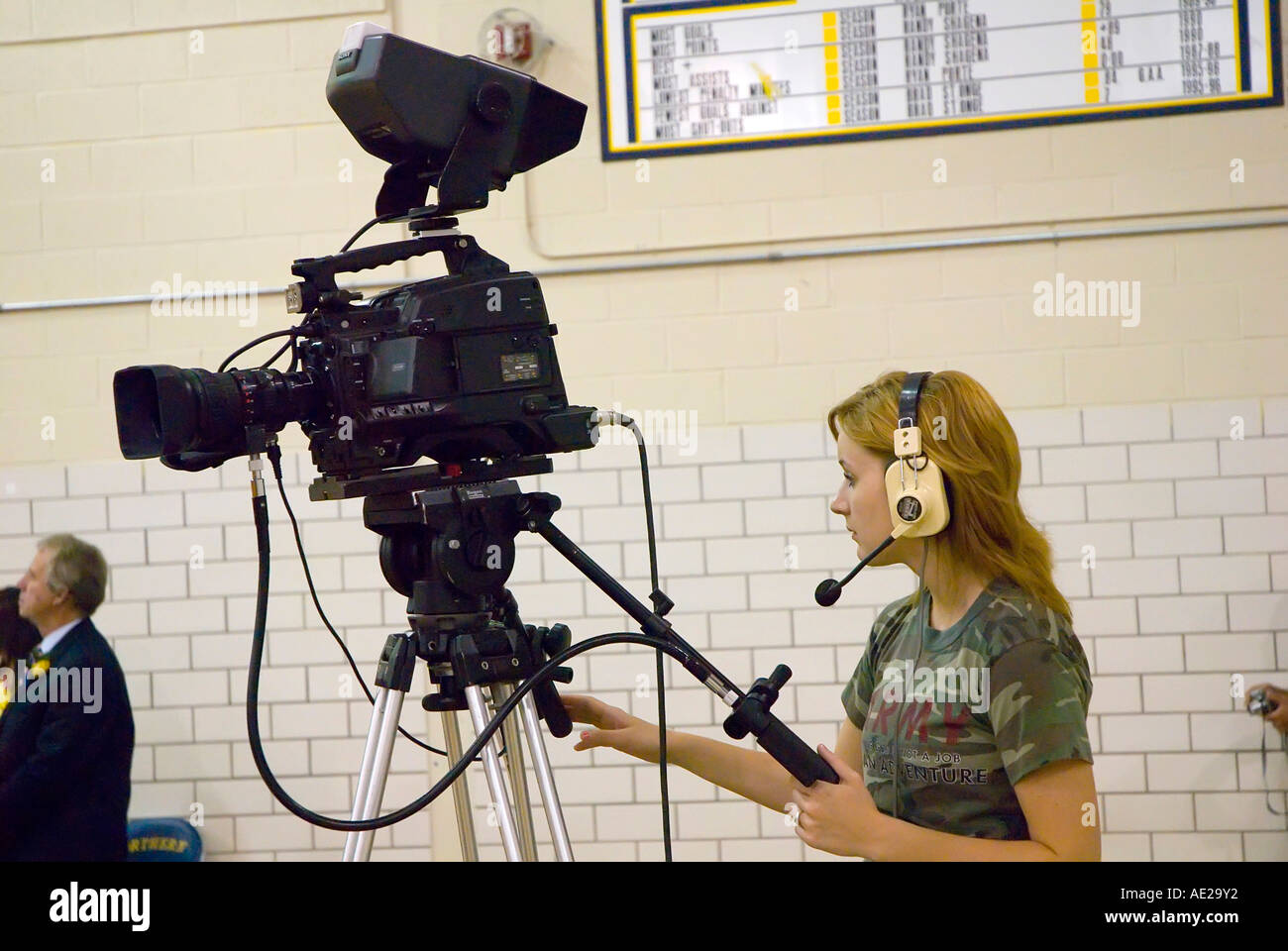 Female television camera person covers a high school graduation event ...