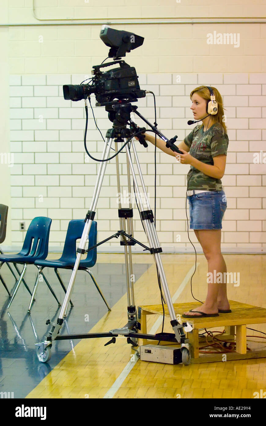 Female television camera person covers a high school graduation event ...