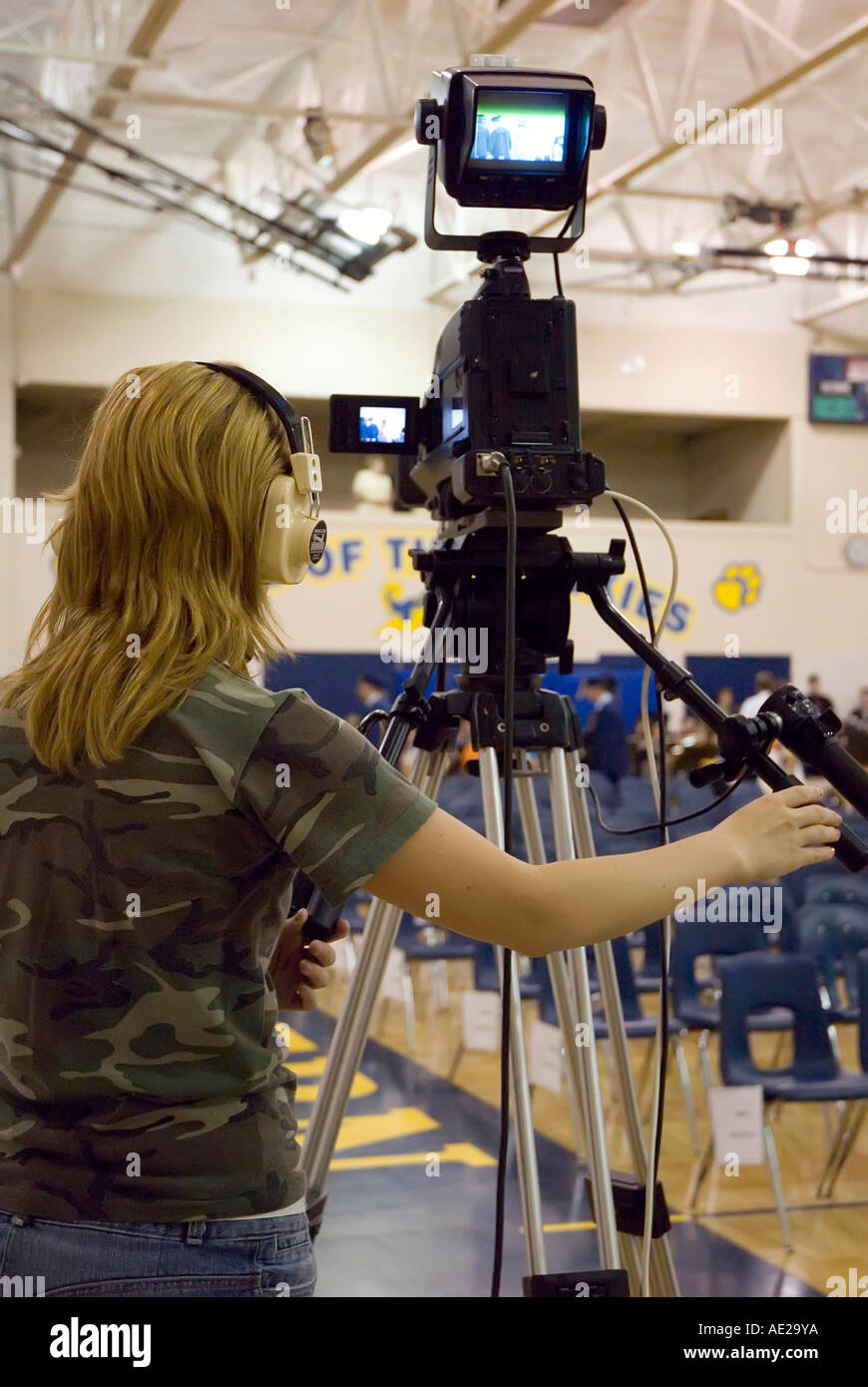 Female television camera person covers a high school graduation event ...