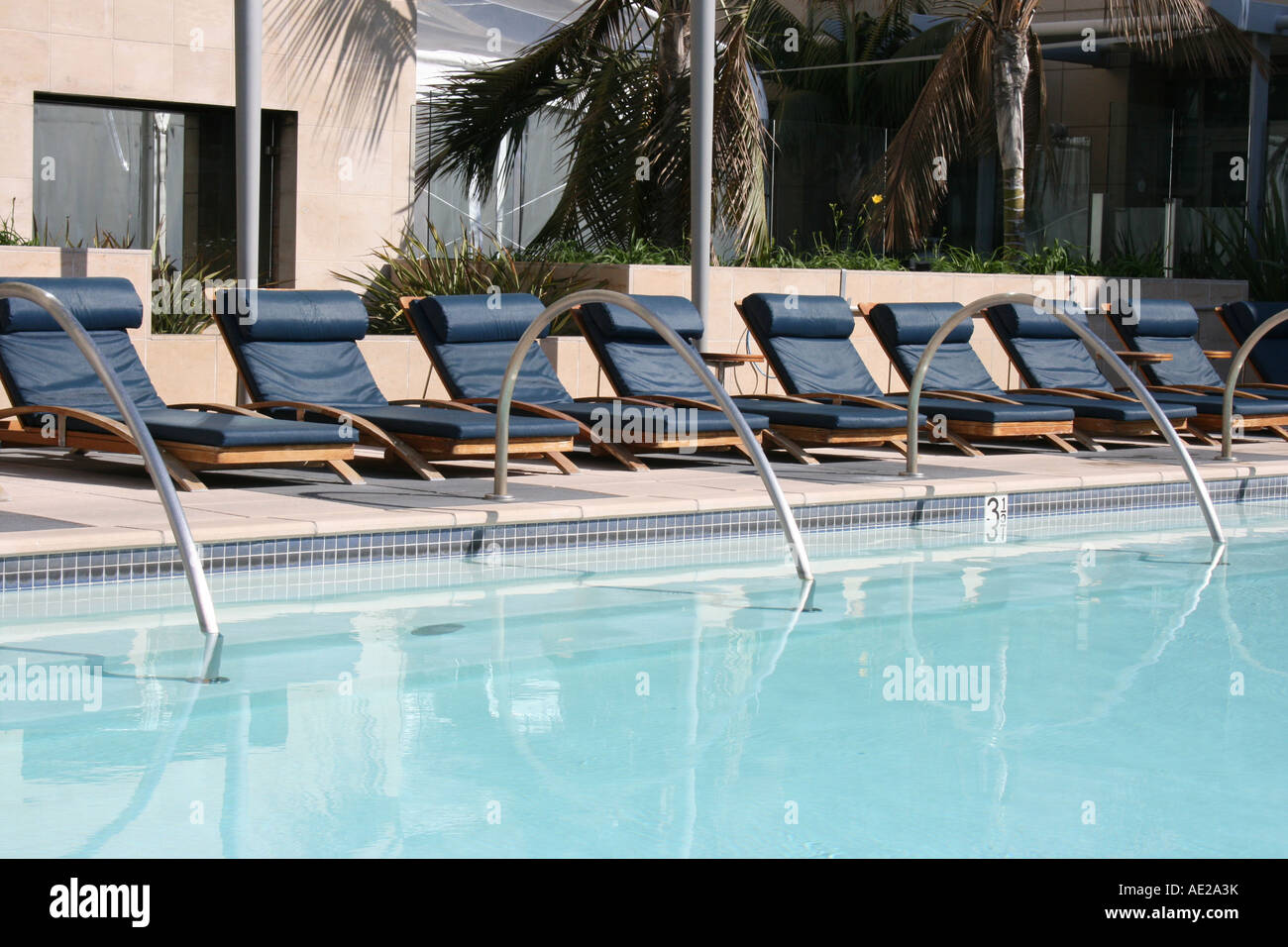 Relaxing by the pool Stock Photo - Alamy