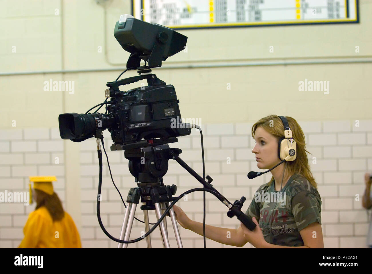 Female television camera person covers a high school graduation event ...
