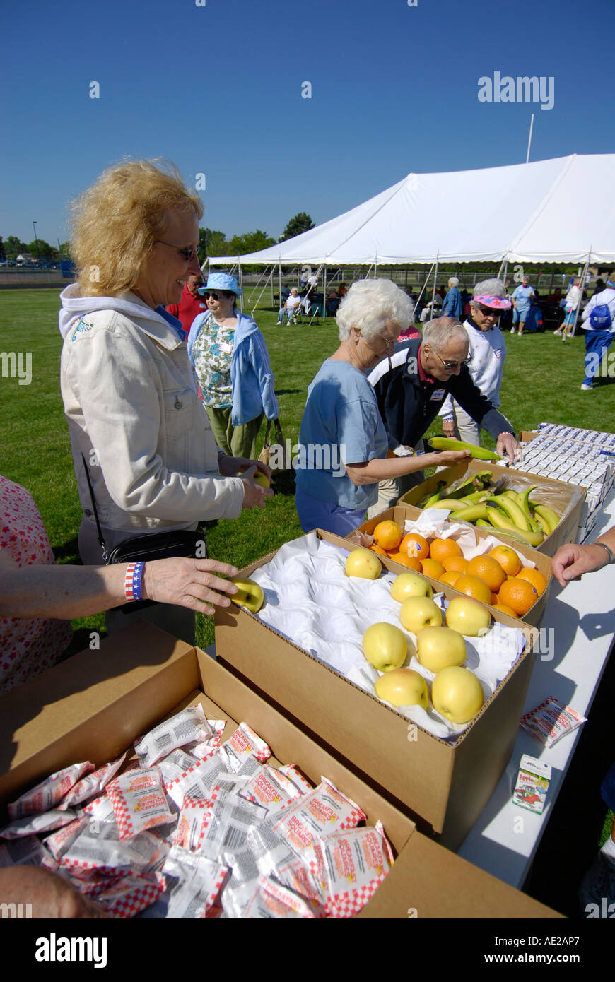 Seniors are offered healthy snack during a Senior Olympic track and ...