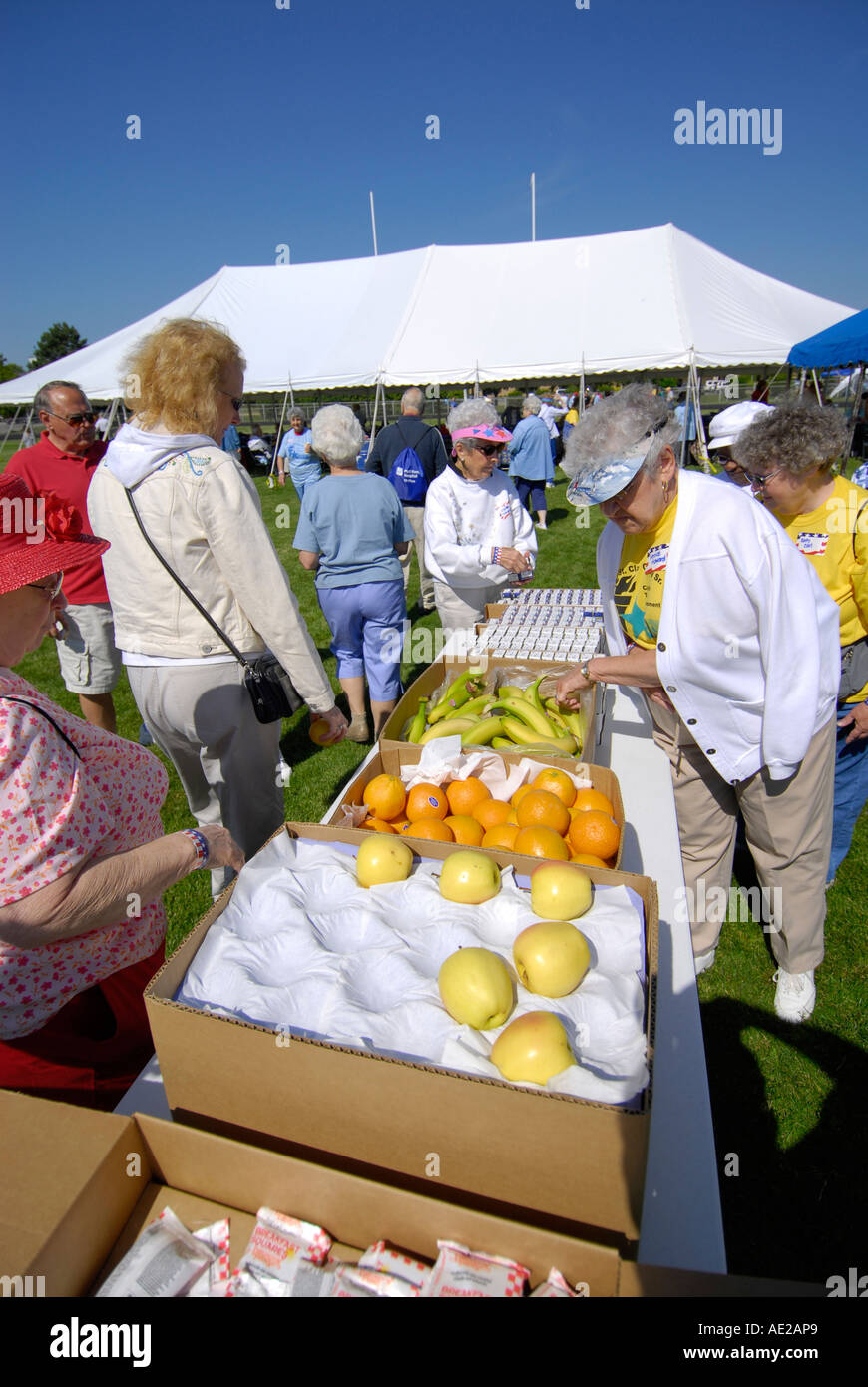 Seniors are offered healthy snack during a Senior Olympic track and ...