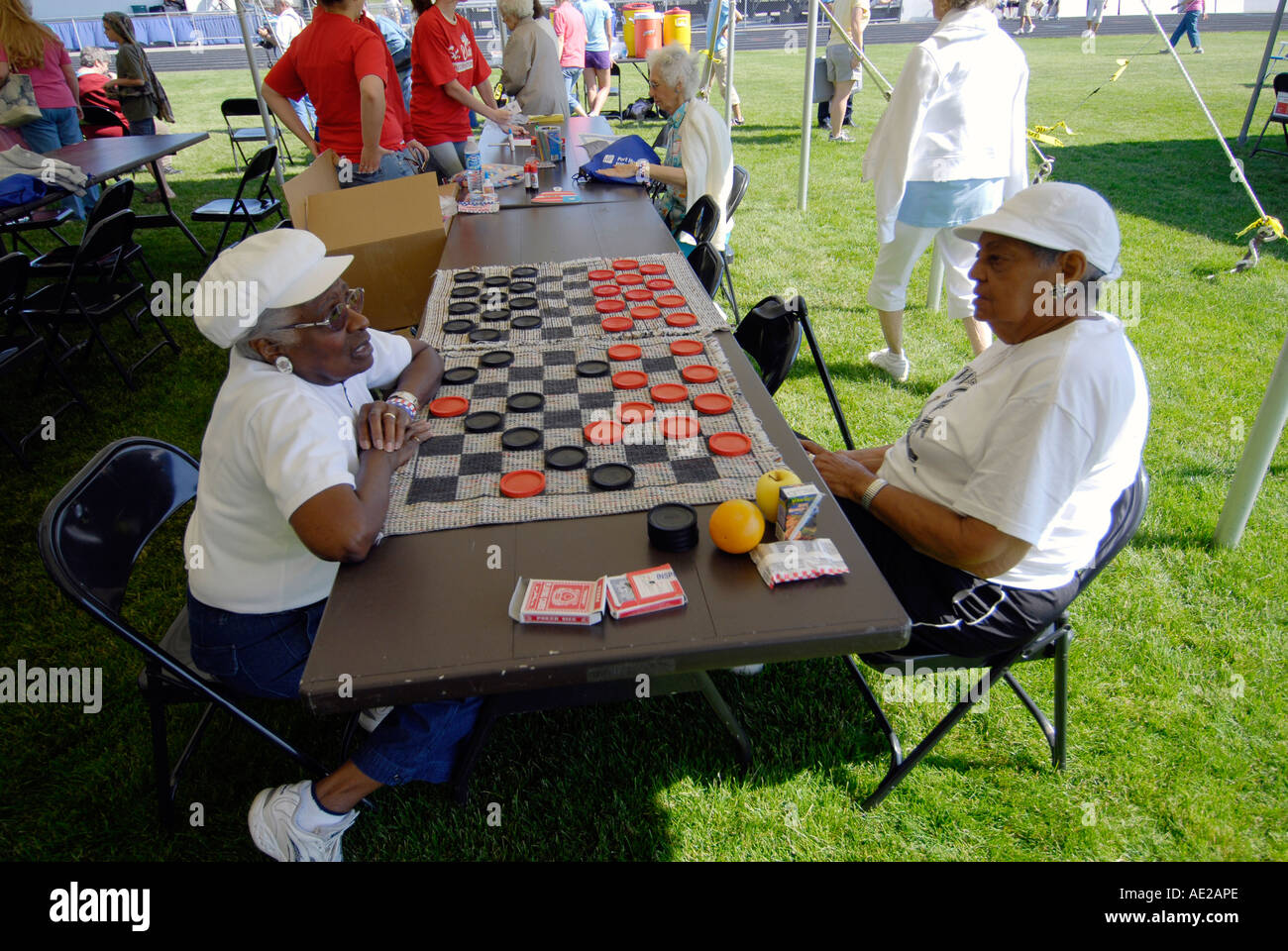 Adult senior female friends play checkers Stock Photo - Alamy