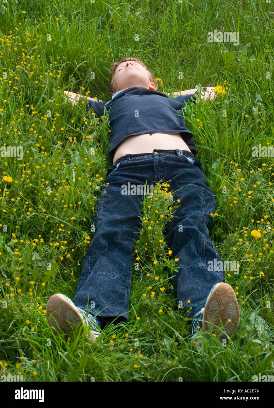 Boy relaxing in the grass Stock Photo - Alamy