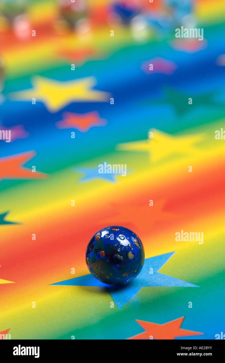 Blue glass marble on stars background Stock Photo - Alamy