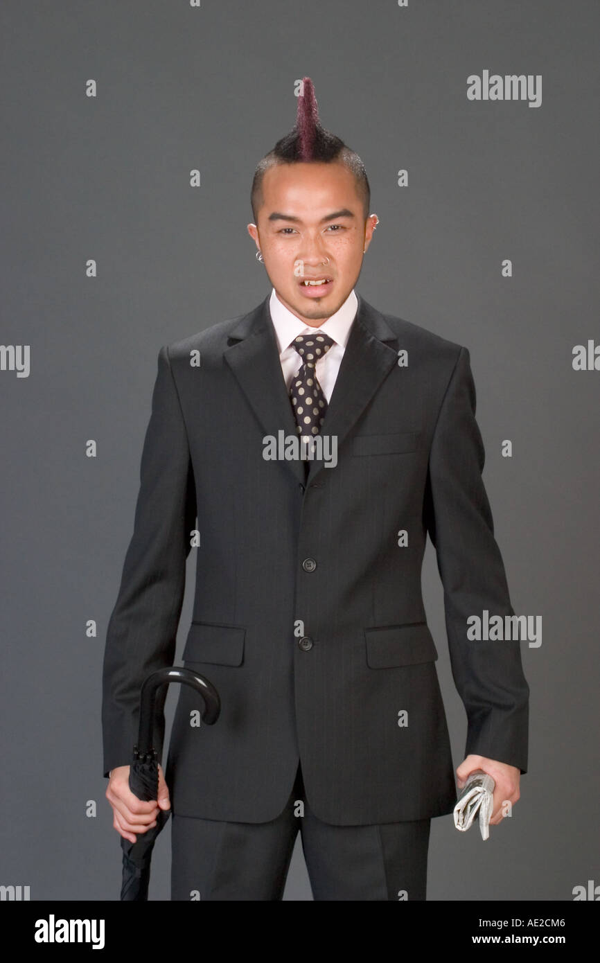 Asian Punk in business suit with agressive stance looking directly ...