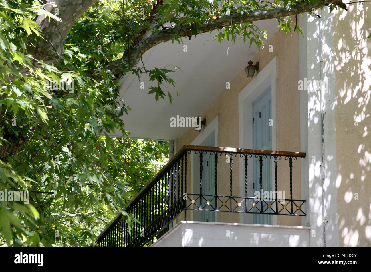 Balcony of house shaded from sun buy dappled shadow Karia Lefkas Greece ...