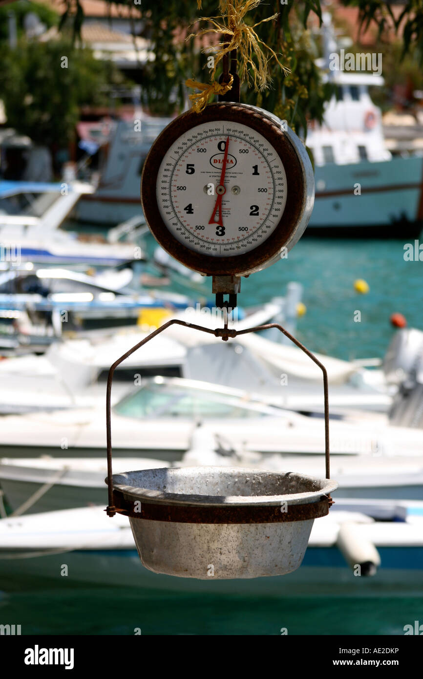 Weighing scales with fishing boats behind in the harbour of Vasiliki ...