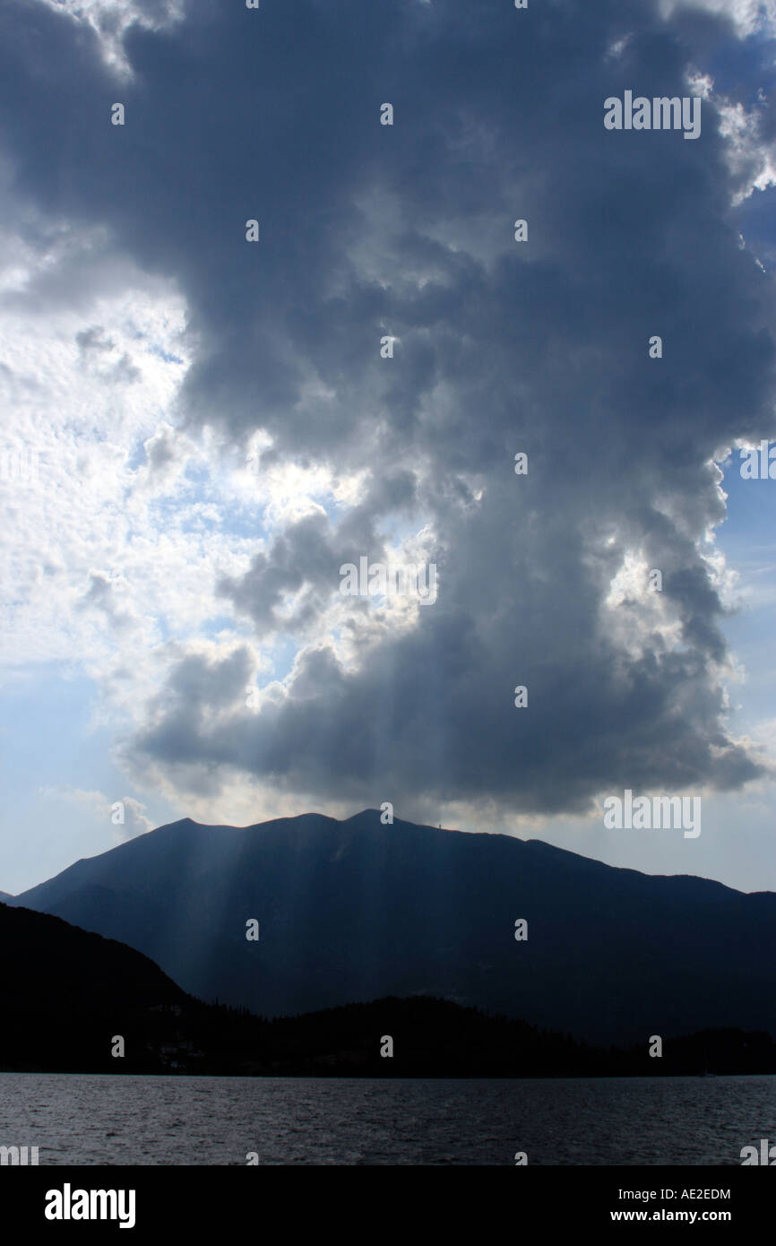 Rays of sun streaking through dark stormy clouds, Greece Stock Photo ...