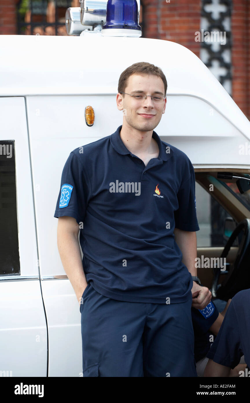 Ambulance man leaning against an ambulance Stock Photo - Alamy